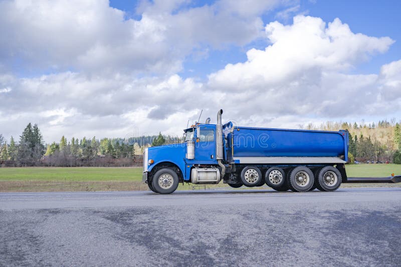Profile of the Blue Big Rig Tip Truck with Two Tipper Trailers Running ...