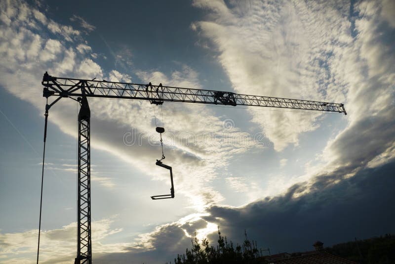 The Profile of a Construction Crane at Sunset Stock Image - Image of ...
