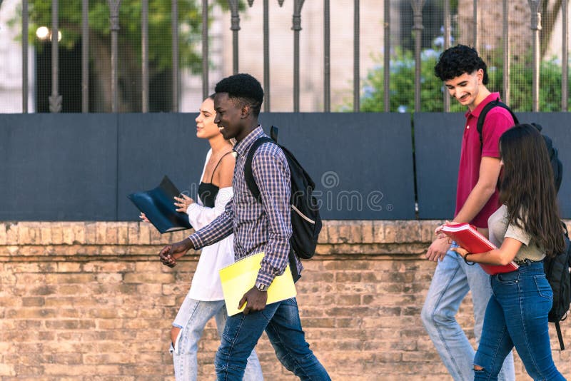 Profile of a Group of Four Students of Different Ethnicities Walking in ...