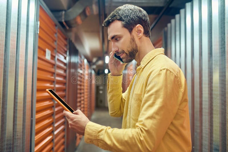 Profile of Man with Tablet Communicating by Smartphone Stock Image ...