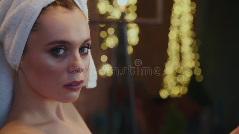 Profile Of Naked Woman Touches Her Neck And Looks At Camera Stock