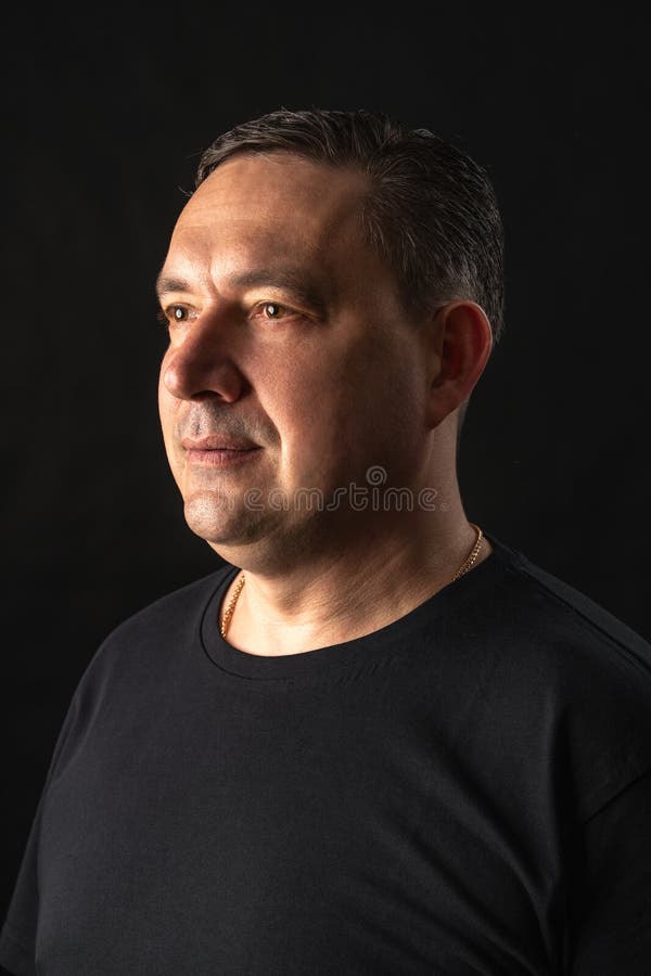Profile Portrait of Man Set Against Dark Backdrop. Studio Shot with ...