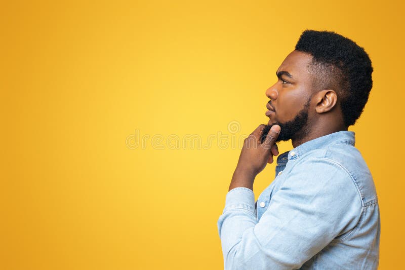 Profile Portrait of Thoughtful African American Guy Over Yellow ...