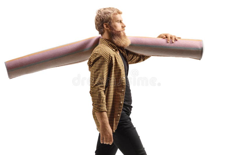 Profile Shot of a Guy Walking and Carrying a Carpet on His Shoulder ...