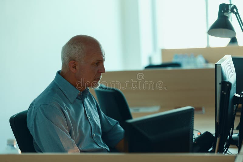 Profile View of Senrio Man Working at Computer. Stock Photo - Image of ...