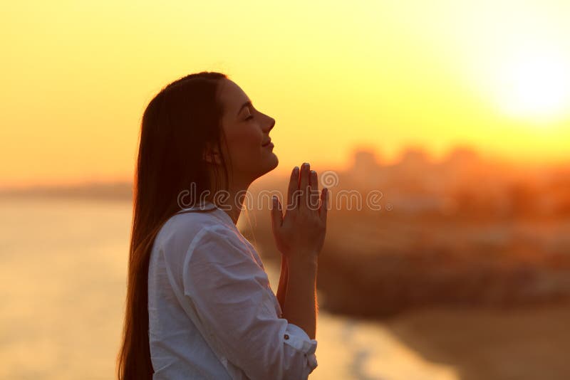 Profile of a Woman Praying at Sunset Stock Photo - Image of female ...