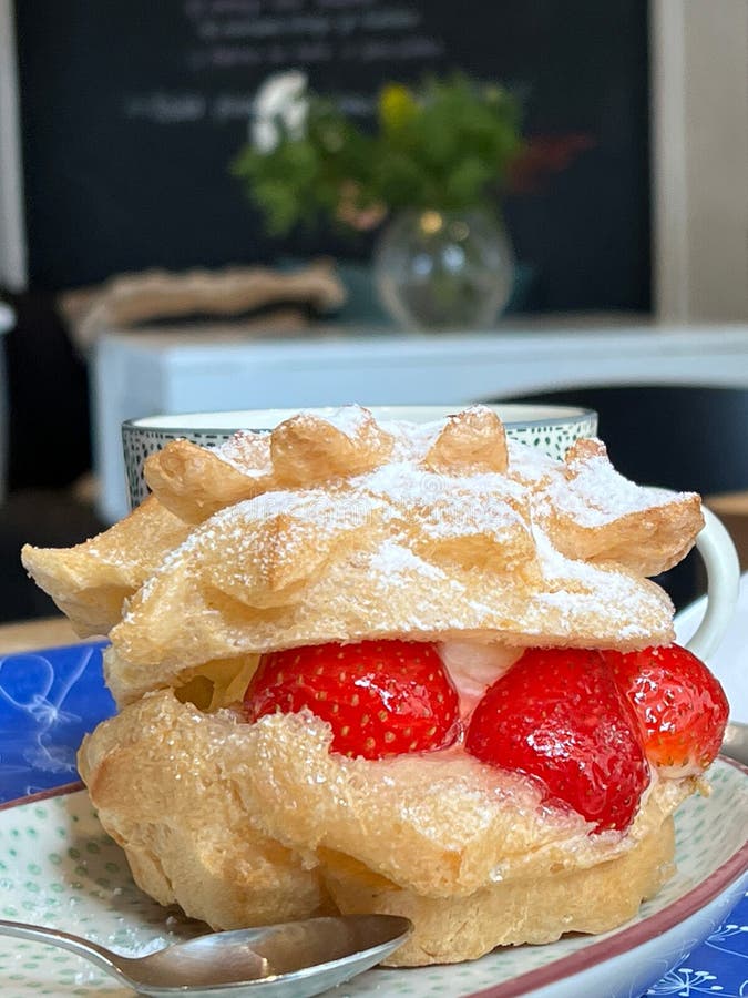 Profiterole with Fresh Strawberries on a Plate, in the Cafeteria. Stock ...