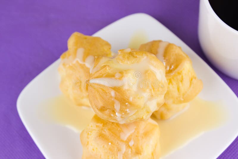 Profiteroles with Coffee on Purple Background Stock Photo - Image of ...