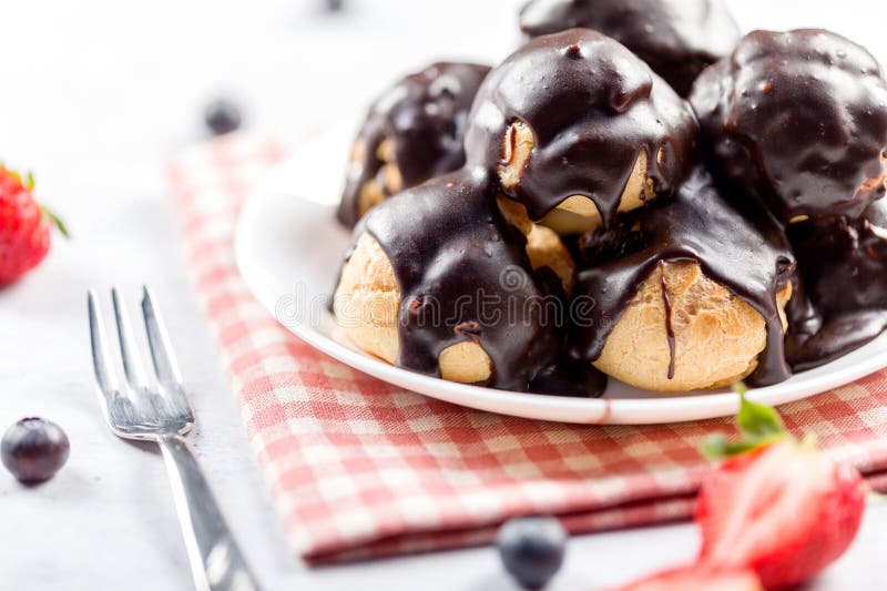 Profitrolls Decorated with Chocolate on a Light Background Stock Image ...