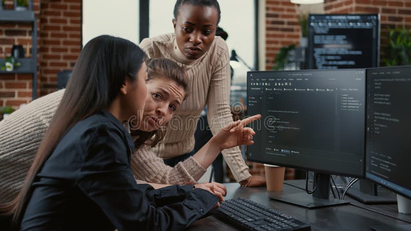 Programer Pointing At Computer Screen Explaining Running Code To Coworkers Brainstorming