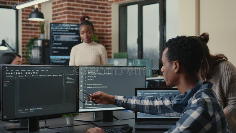 Programmer Analyzing Compiling Code on Multiple Screens Takes Off Glasses and Doing High Five ...