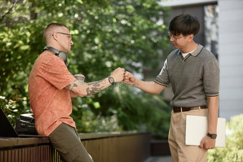 It Programmer Bumping Fists with Partner during Meeting in Park Stock ...