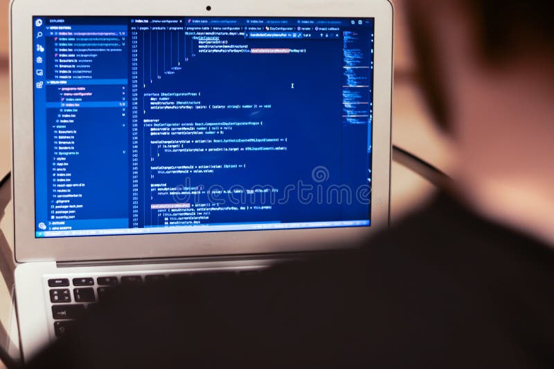 Programmer is Developing an Application. Programming on a Laptop and ...