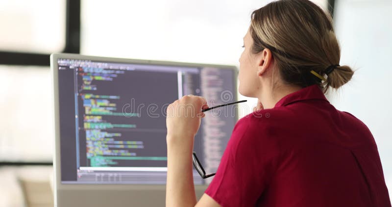 Programmer with Glasses in Hand Checkups Code on Computer Stock Footage ...