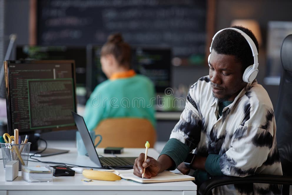 Programmer Making Notes in Notebook Stock Photo - Image of development ...
