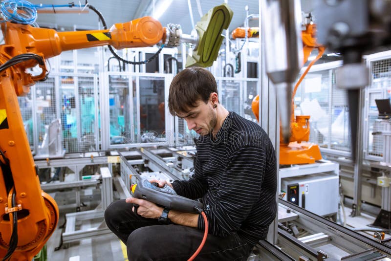 Programmer Programming Automatic Robot Arms in Automotive Smart Factory ...