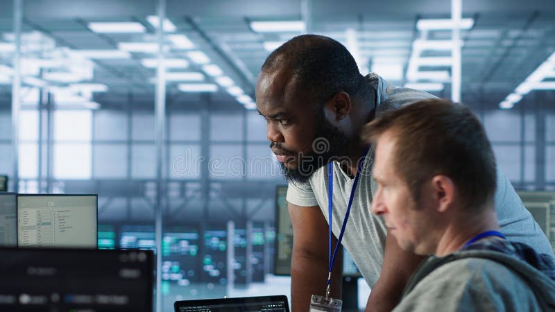 Programmer Requesting Help from Manager while Working on Computer in Data Center Stock Image ...
