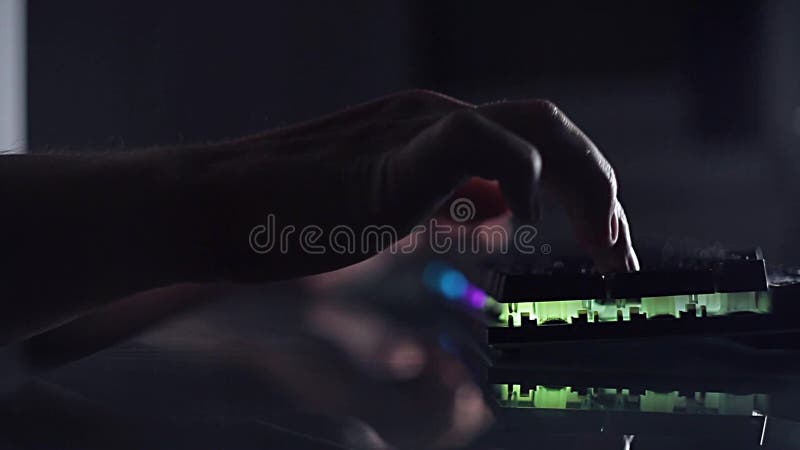 Programmer Typing Code on a Backlit Keyboard in a Dark Room, Passionate ...