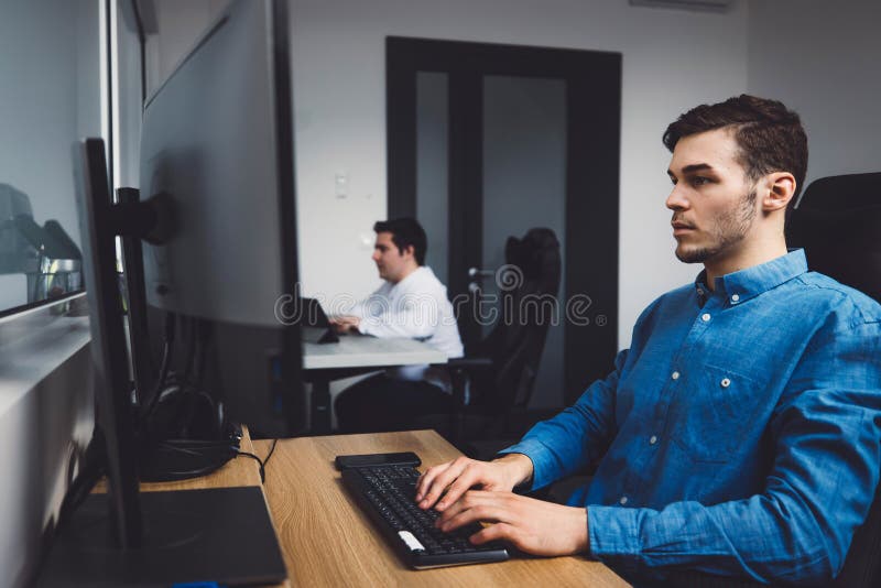Side View, Two Programmers Working in the Office Coding on Desk Top ...