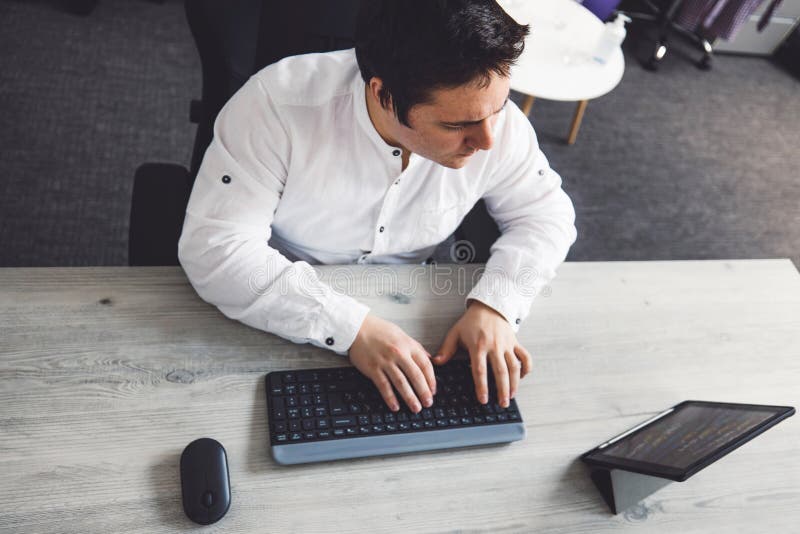 Top Down View Programmer Sitting at His Desk in the Office Typing on a Wireless Keyboard Stock ...