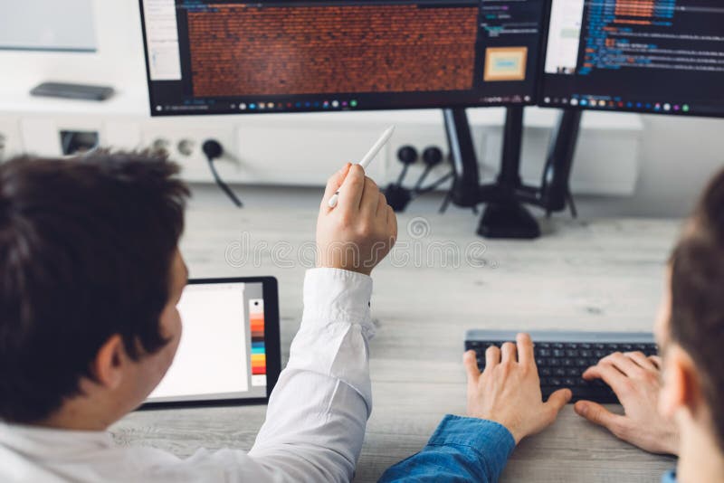 Over the Shoulder Close Up View Two Programmers Developing New App at ...