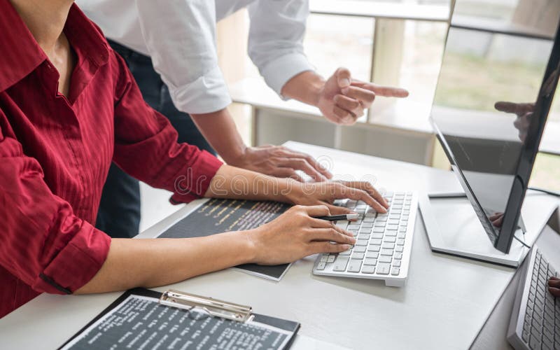 Programmers Cooperating at Developing Programming and Website Working in a Software Develop ...