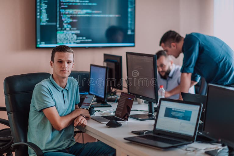 Programmers Engrossed in Deep Collaboration, Diligently Working Together To Solve Complex ...