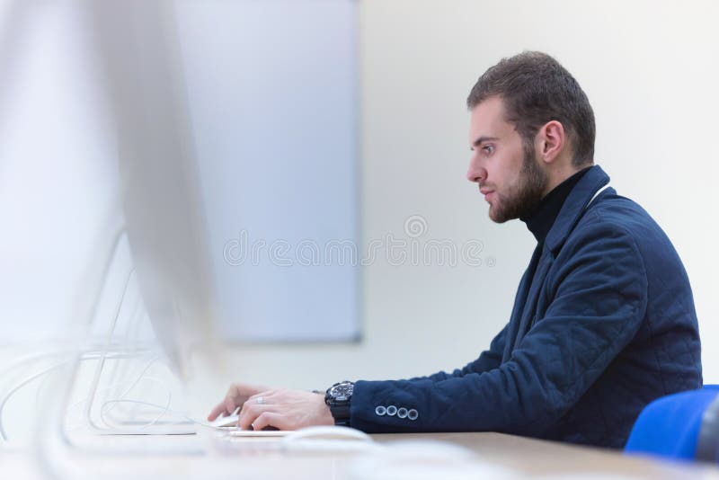 Programming Man Working On Computer In It Office Sitting At Desk Writing Codes Stock Image