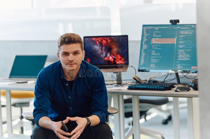 Programming Man Working On Computer In It Office Sitting At Desk Writing Codes Stock Image