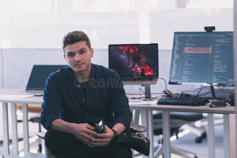 Programming Man Working On Computer In It Office Sitting At Desk Writing Codes Stock Image
