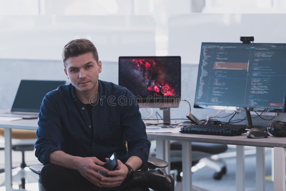 Programming Man Working On Computer In It Office Sitting At Desk Writing Codes Stock Image