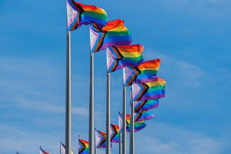 Progress Pride Flags Waving Over Blue Sky Stock Photo - Image of ...