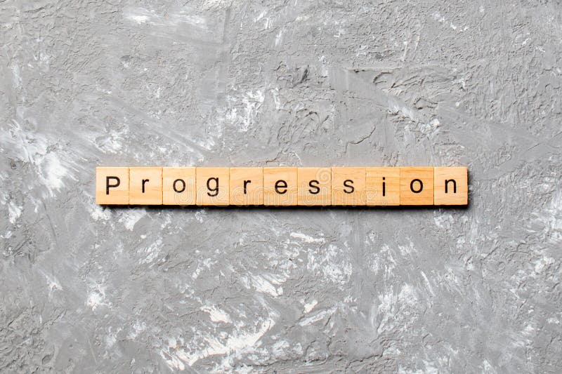 Progression Word Written on Wood Block. Progression Text on Cement ...