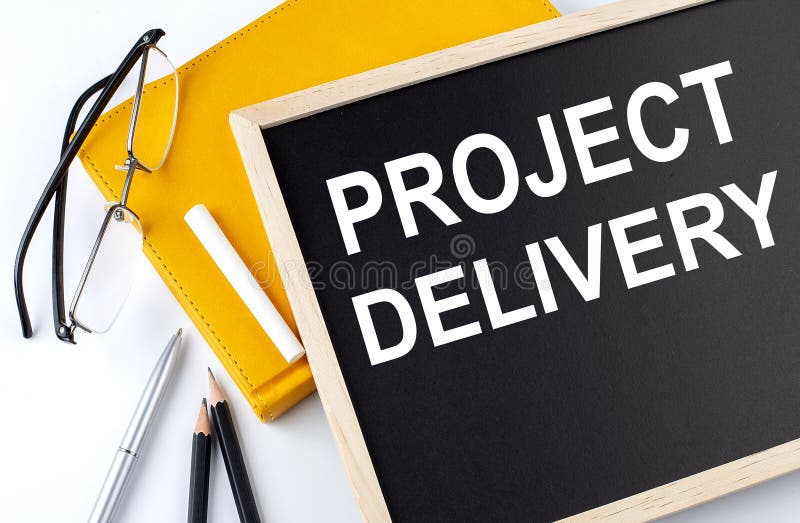 PROJECT DELIVERY Text on the Blackboard with Notepad , Pen, Pencil ...