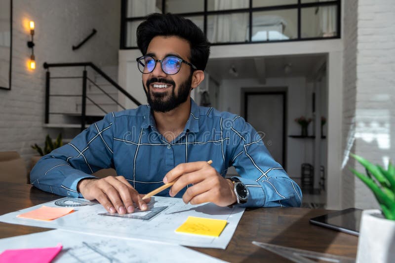 Dark-haired Young Man Sitting at the Table and Preparing a Project ...