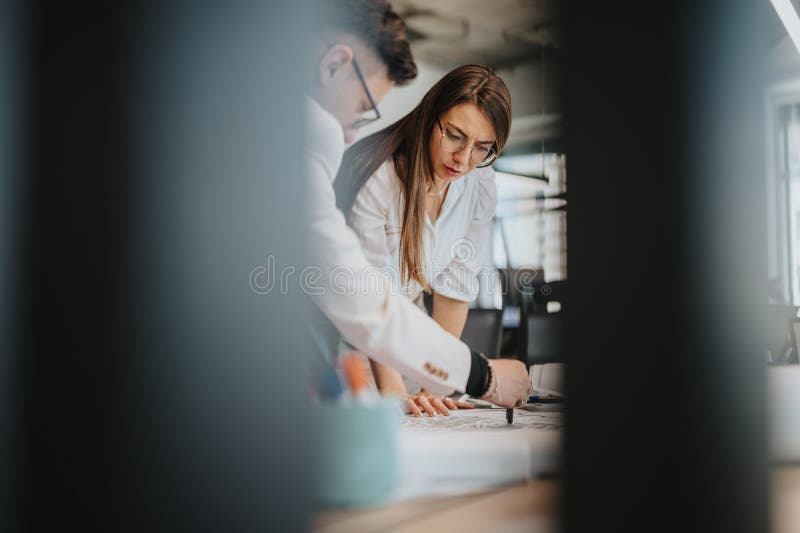 Focused Team Collaboration on Project Paperwork in Modern Office ...