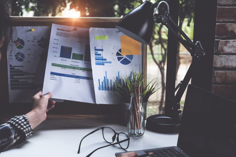 Project Management Updating Financial Chart with Paperwork on Board ...
