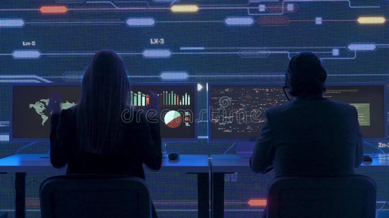 Technical Support Team in Control Room. Man and Woman Specialists ...