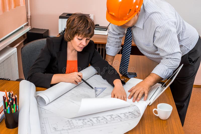 Project Manager and Engineer Discussing Building Plans in the of Stock ...