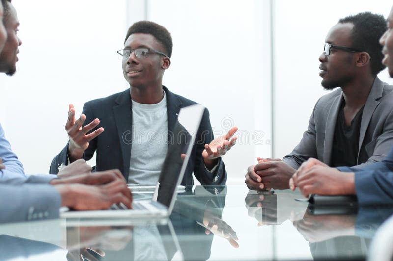 Project Manager Explaining Something To Employees at an Office Meeting ...