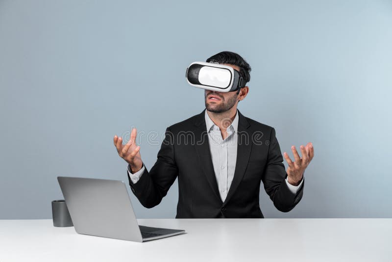 Project Manager Looking by Using VR Goggle while Sitting at Laptop ...