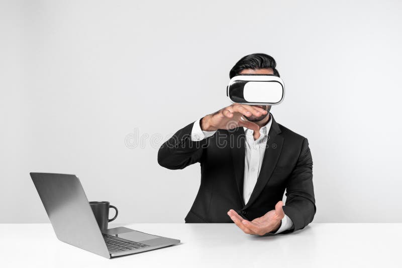 Project Manager Looking by Using VR Goggle while Sitting at Laptop ...