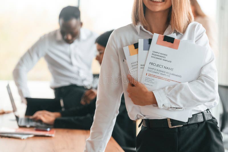 Project Manager is Standing with Documents. Group of Office Workers are ...