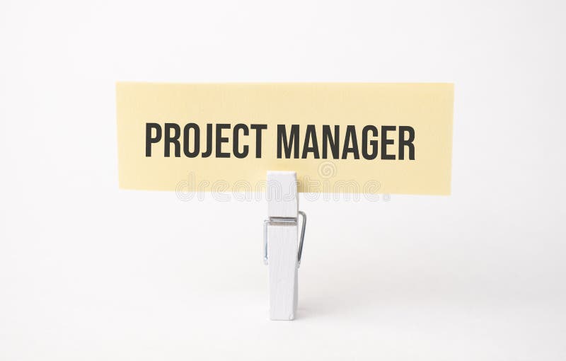 PROJECT MANAGER Sign on Paper on Dark Desk in Sunlight. Blue and White ...