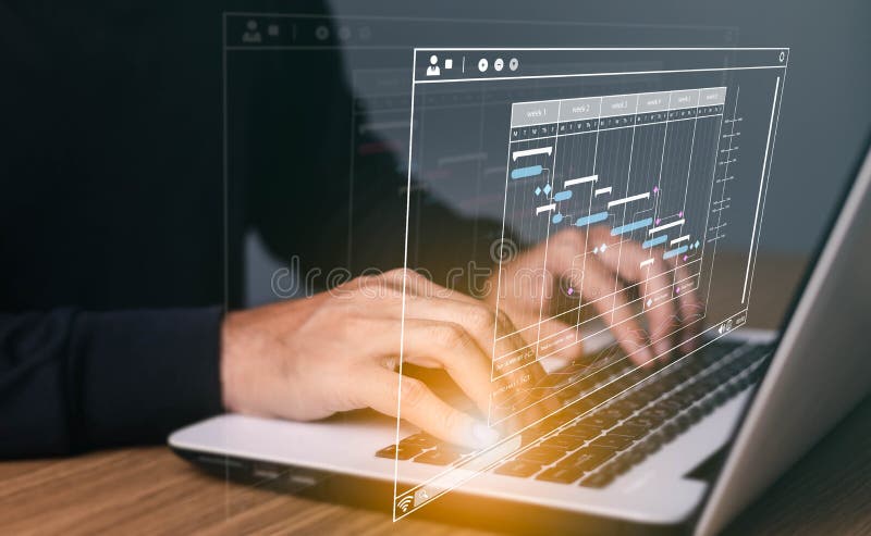Project Manager Working on Laptop and Updating Tasks and Milestones ...