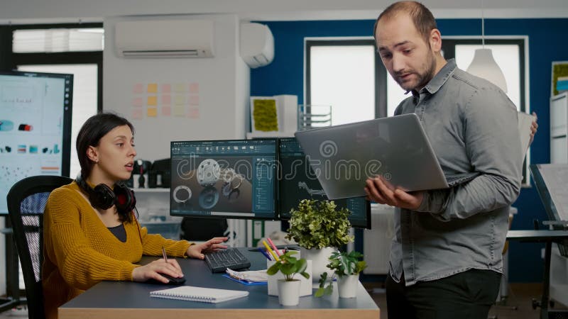 Project Supervisor Holding Laptop and Talking with Woman Engineer Stock ...