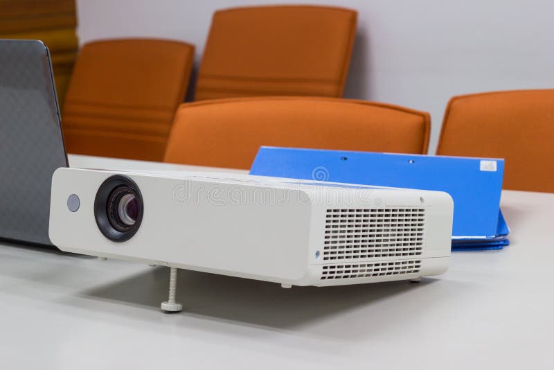 Projector Connected To Laptop with File Folder on the Table in a ...