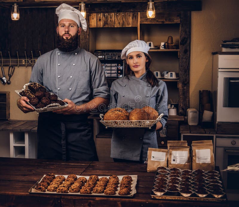 Chef with His Assistant Showing Fresh Bread in the Kitchen. Promotion ...