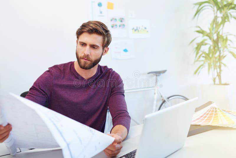 Proofreading the Plans. a Young Architect Looking Over Some Building ...