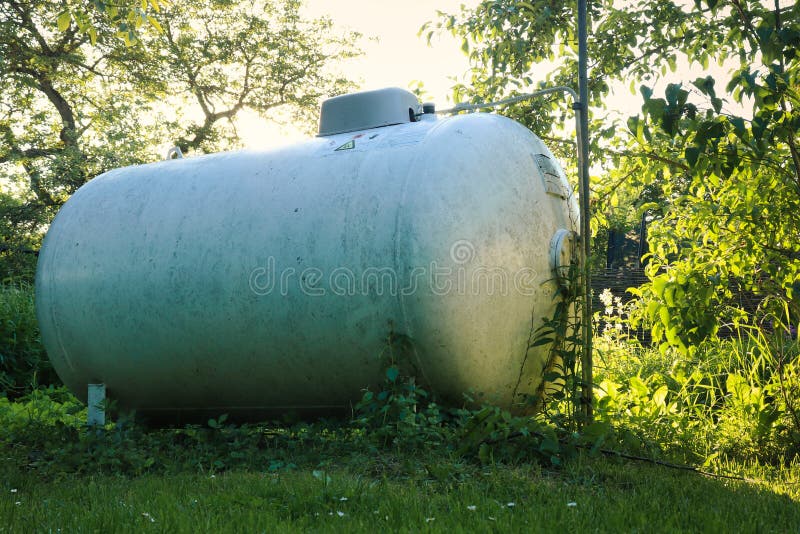 Propane tank in a backyard stock image. Image of energy - 211595281